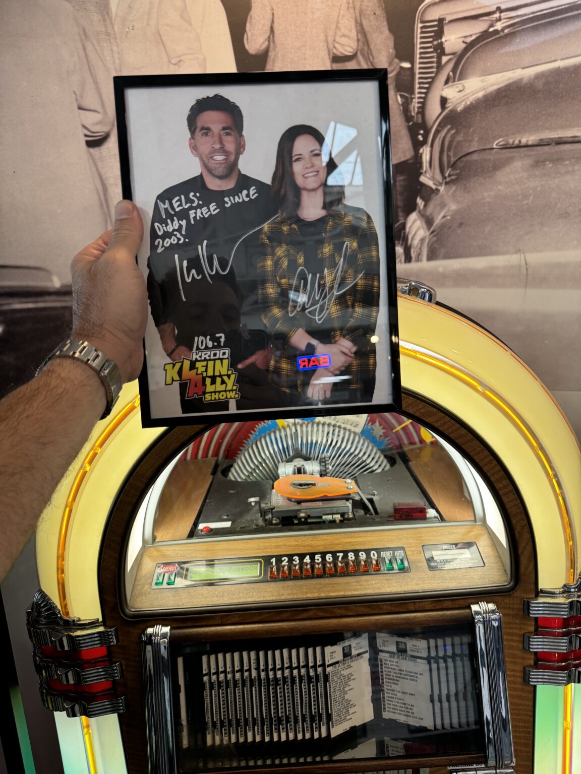 KROQ's morning show replaces Diddy photo at Mel's Hollywood | Audacy Inc.